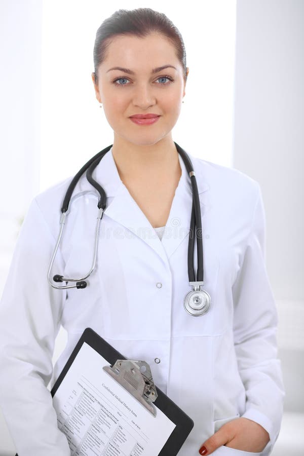 Brunette Female Doctor Standing Straight At Hospital Medicine And