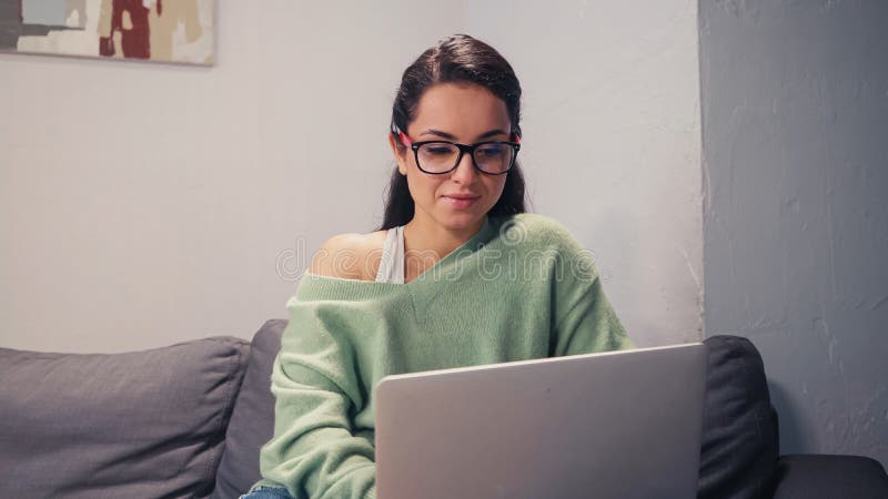 Brunette Freelancer Using Laptop on Couch Stock Image - Image of ...