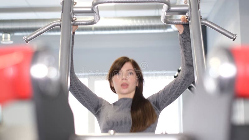 Brunette Girl Doing Pull-ups in the Gym. a Professional Athlete ...