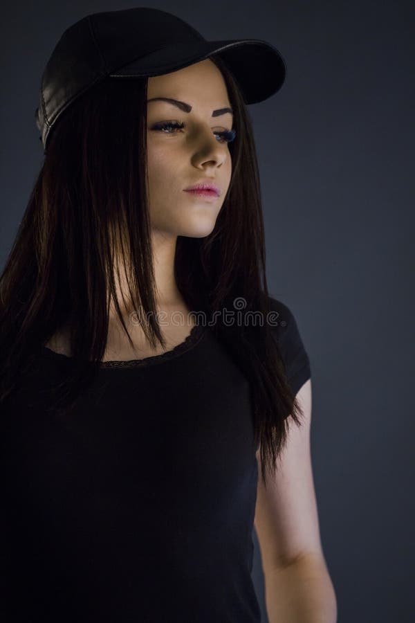Brunette Girl Holding Her Cap while Posing Studio Stock Photo - Image ...