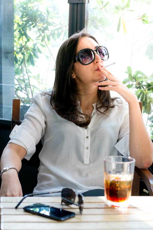 Brunette Having a Smoke in a Cafe Stock Photo - Image of people, light ...