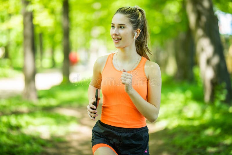 A Brunette Runner Woman Runs in the Park Jogging Stock Image - Image of ...