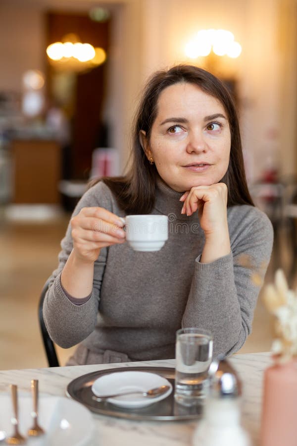 Brunette Sitting in Cozy Cafe with Cup of Coffee Stock Image - Image of date, coffee: 358772431