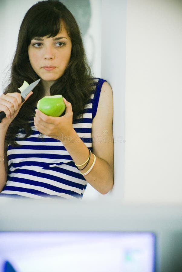 Brunette Standing/eating Apple Stock Image - Image of looking, diet ...