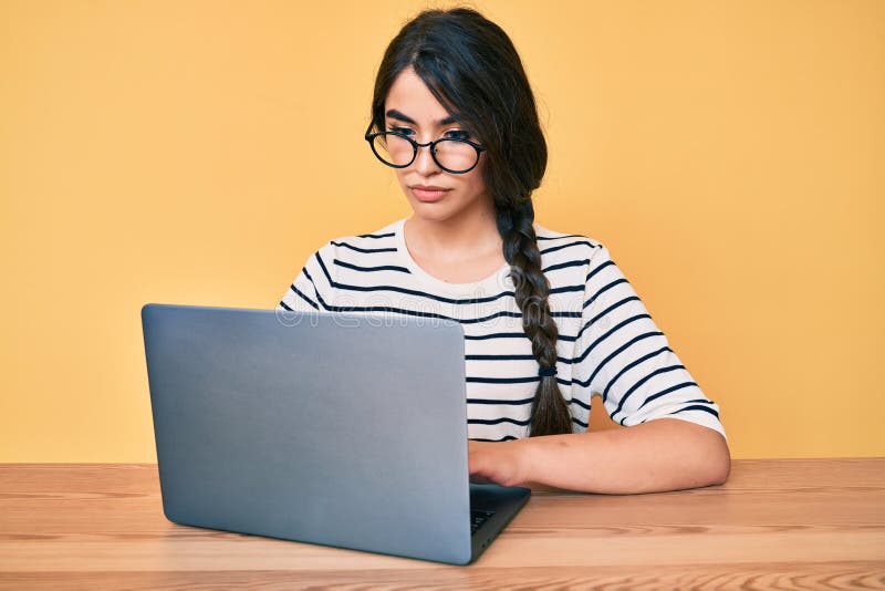 Brunette Teenager Girl Working Using Computer Laptop Thinking Attitude ...
