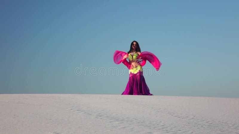 Brunette with a Veil in Her Hands Dances a Belly Dance in the Desert ...