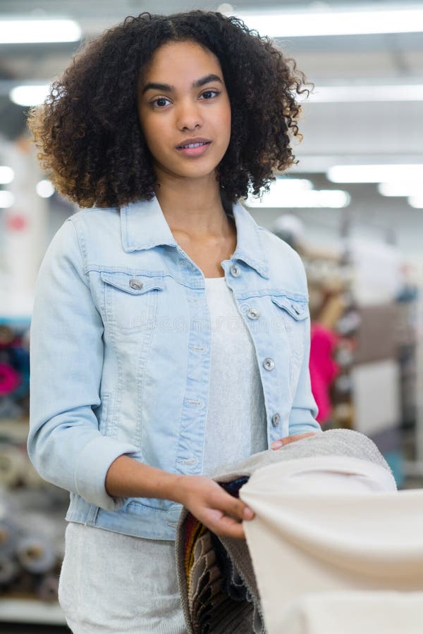 Brunette Woman Choosing Fabric in Textile Shop Stock Photo - Image of ...