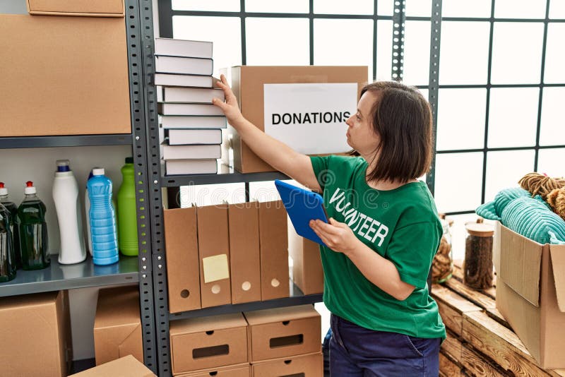 Brunette Woman with Down Syndrome Checking Donations on Tablet at ...