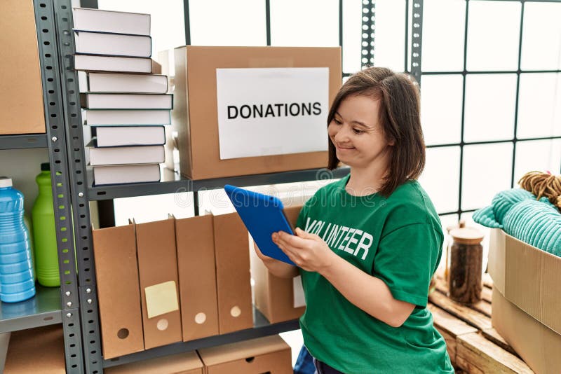 Brunette Woman with Down Syndrome Checking Donations on Tablet at ...