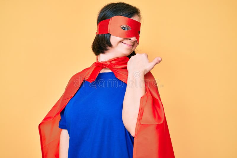 Brunette Woman With Down Syndrome Wearing Super Hero Costume Smiling With Happy Face Looking And
