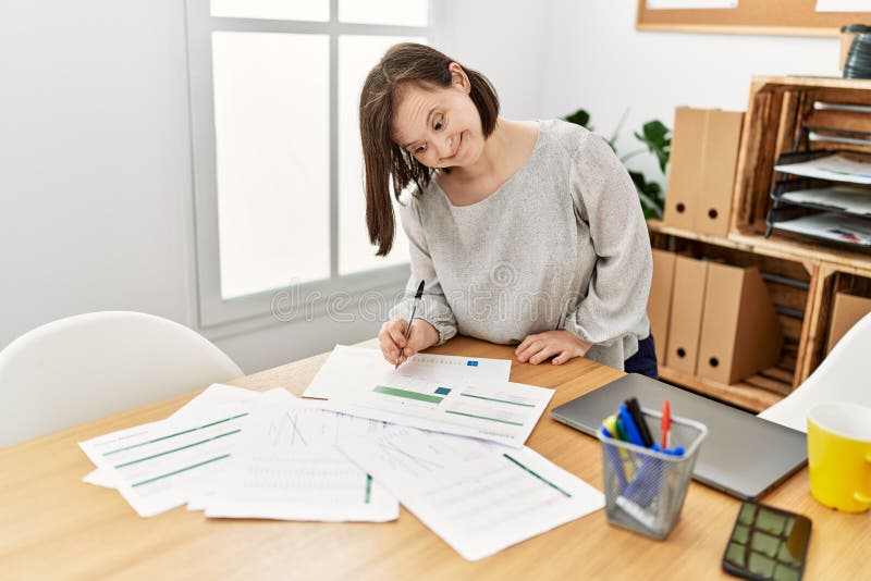 Brunette Woman with Down Syndrome Working with Documents at Business ...