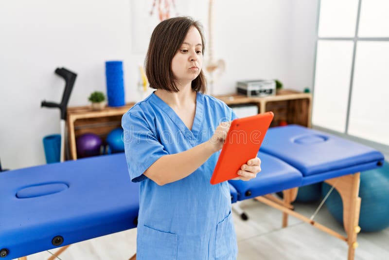 Brunette Woman with Down Syndrome Working Using Tablet at Physiotherapy ...