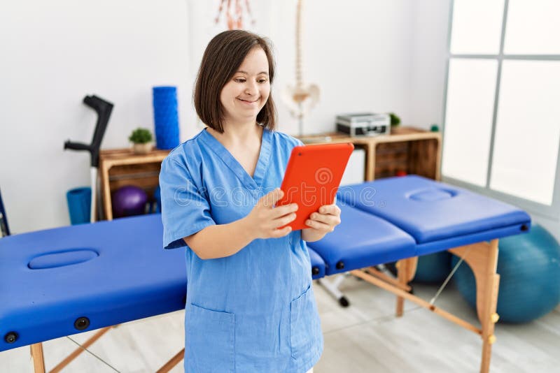 Brunette Woman with Down Syndrome Working Using Tablet at Physiotherapy ...