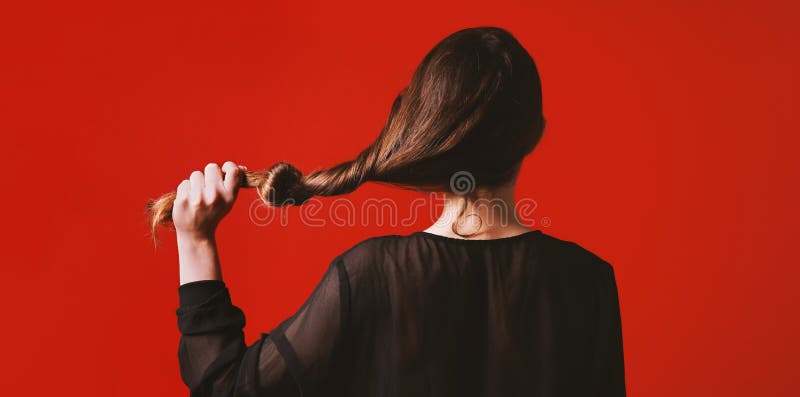Brunette Woman Pulling Her Long Hair with Knot it Stock Image - Image ...