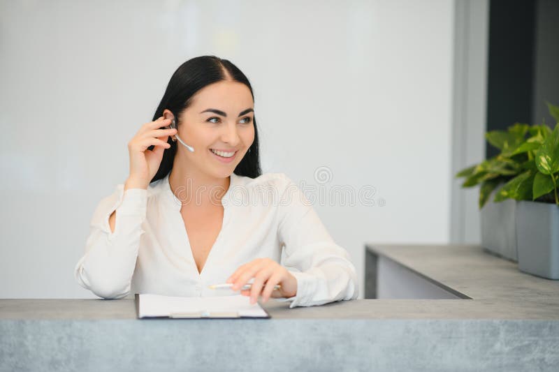 Brunette Woman Receptionist Working in Reception of the Beauty Salon ...