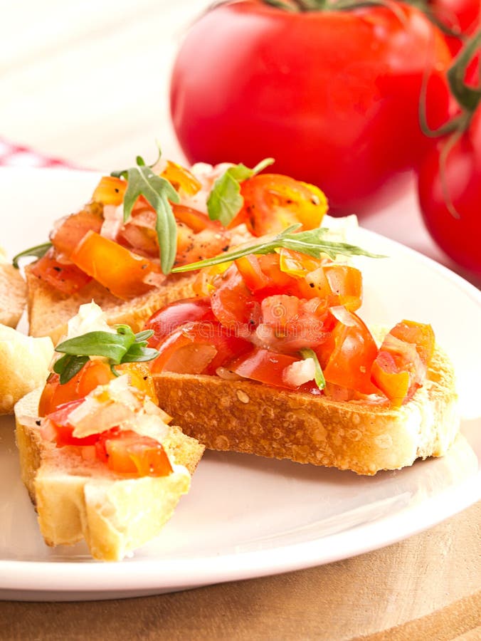 Bruschetta from Tomatoes and Rucola Stock Image - Image of mouthful ...