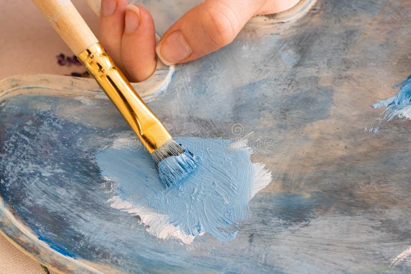 A Brush with Blue Oil Paint Rests on the Palette. Stock Image - Image ...