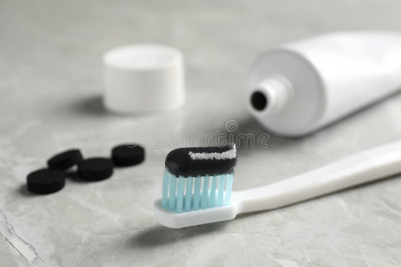 Brush with Charcoal Toothpaste on Light Grey Table, Closeup Stock Image ...