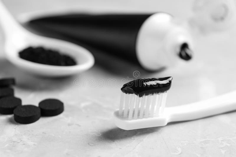 Brush with Charcoal Toothpaste on Light Grey Table, Closeup Stock Image ...