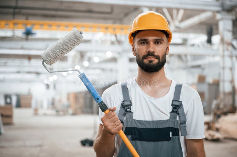 With Brush for Coloring. Industrial Worker in Wooden Warehouse Stock ...