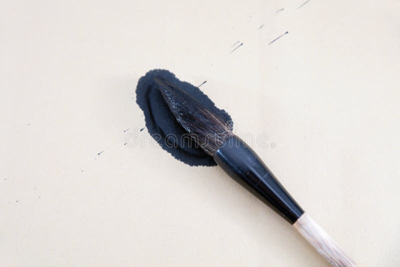 A Brush Full of Ink Falls on the Raw Rice Paper Stock Image - Image of ...