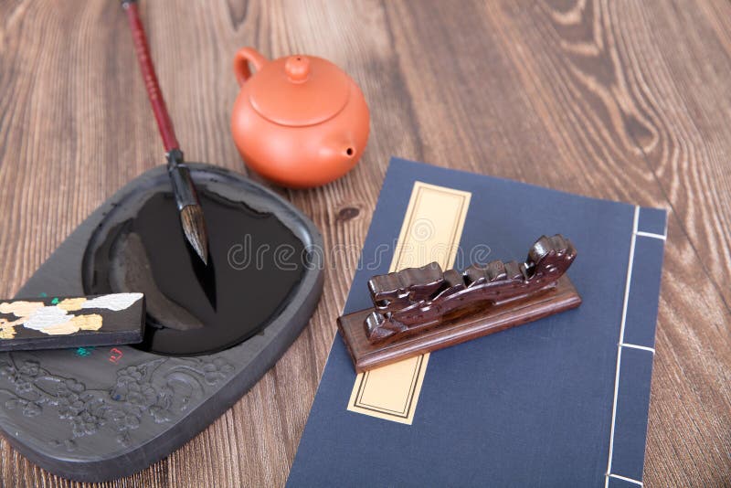 The Brush and Inkstone on the Desk, a Purple Clay Pot and a Book Stock ...