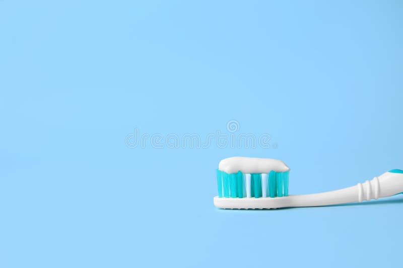 Brush with Toothpaste on Light Blue Background, Space for Text Stock ...