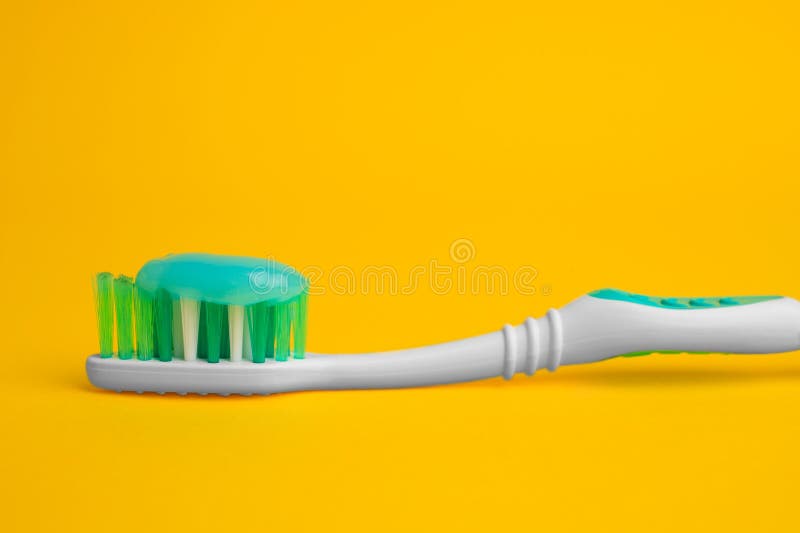 Brush and Toothpaste on Yellow Background, Closeup Stock Photo - Image ...