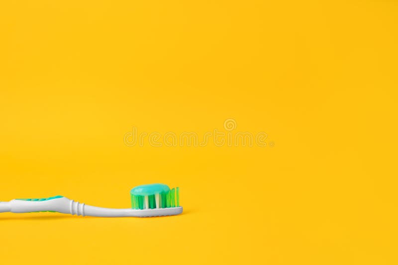 Brush and Toothpaste on Yellow Background, Space for Text Stock Photo ...