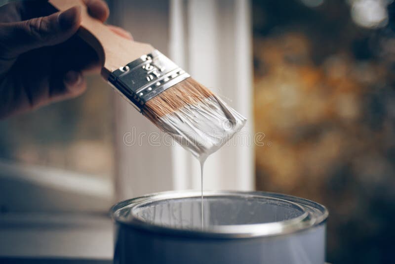Brush in white paint stock photo. Image of housework - 195278814