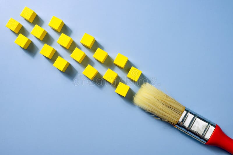 A Brush and Yellow Cubes Like Paint. Creative Modern Art. Stock Photo ...