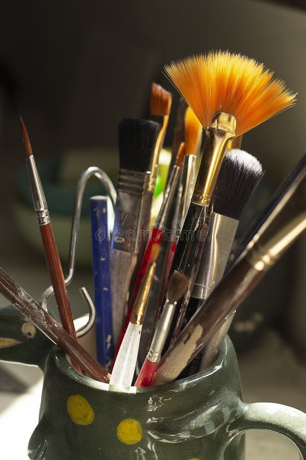 Brushes of Different Size and Thickness Inside a Ceramic Container on a ...