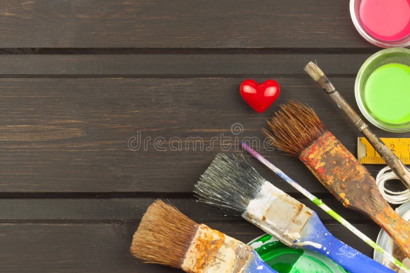 Brushes and Paint on a Wooden Table. Painter Tools. Workshop Painter ...