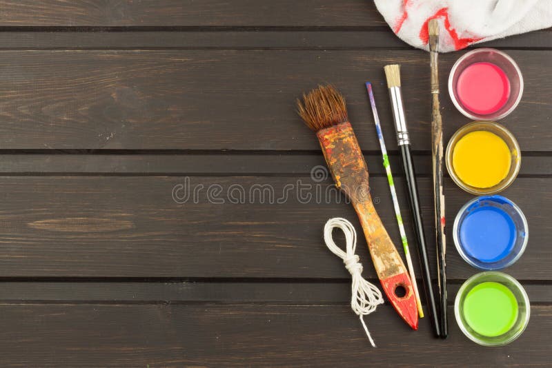 Brushes and Paint on a Wooden Table. Painter Tools. Workshop Painter ... Brushes and Paint on a Wooden Table. Painter Tools. Workshop Painter ...
