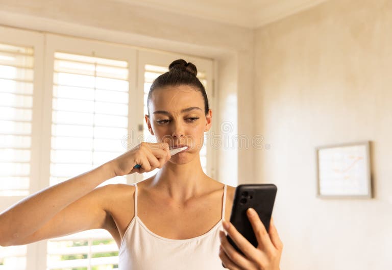 Brushing Teeth, Woman Using Smartphone and Looking at Screen in ...