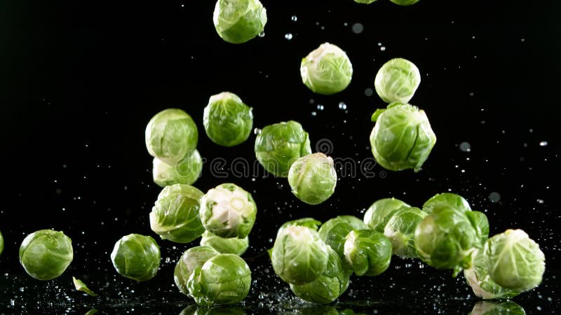 Brussels Sprouts Falling on Black Background Stock Photo - Image of ...
