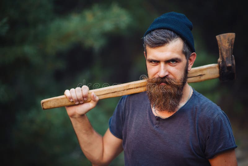 Brutal Bearded Man with a Smart Mustache with an Ax in His Hands in the ...
