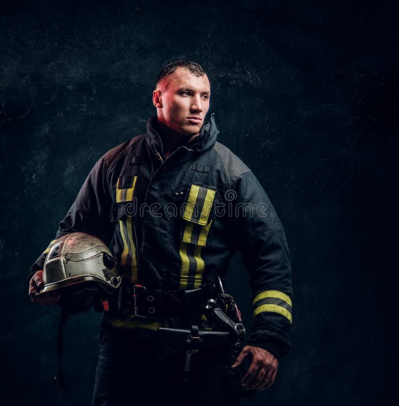 Brutal Firefighter in Uniform and Safety Helmet Holding an Oxygen Mask ...