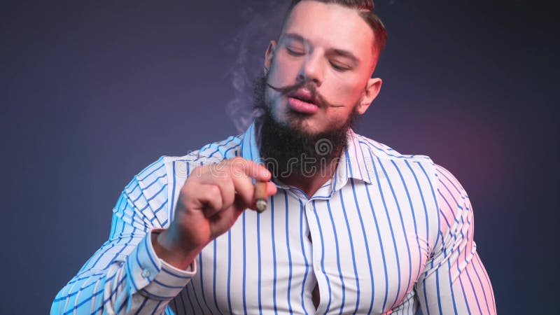 Brutal and Handsome Bodybuilder with Beard and Moustache Smoking Cigar ...