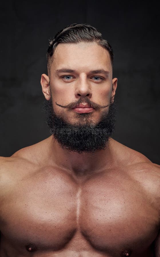Bodybuilder with Beard Posing with Crossed Arms in Studio Stock Photo ...