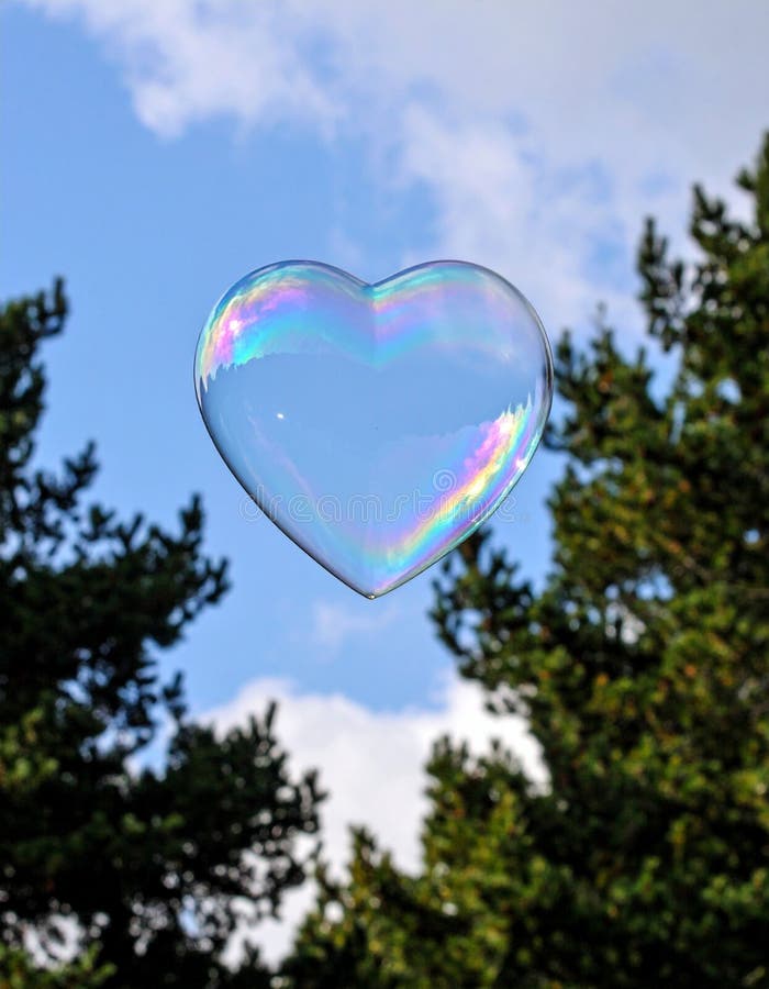 A Bubble Suspended Mid-air Captured in a Perfect Iridescent Heart Shape ...