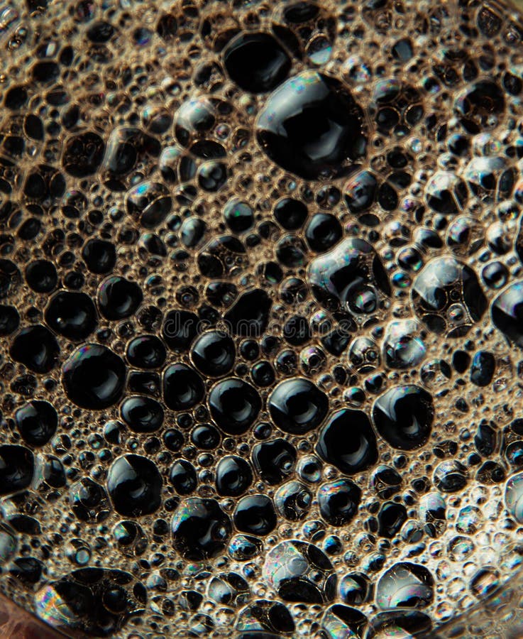 Bubbles of a Dark Beverage Create a Textured Surface, Reflecting Light ...