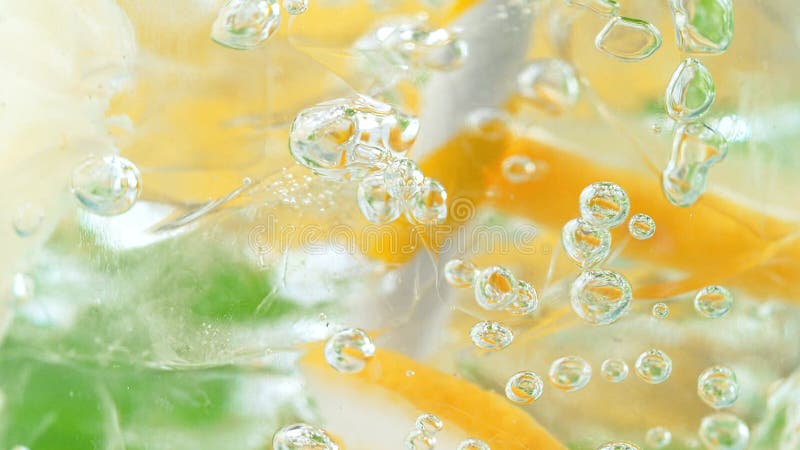 Bubbles Squeezing through the Lemonade Ingredients in the Glass - Macro ...