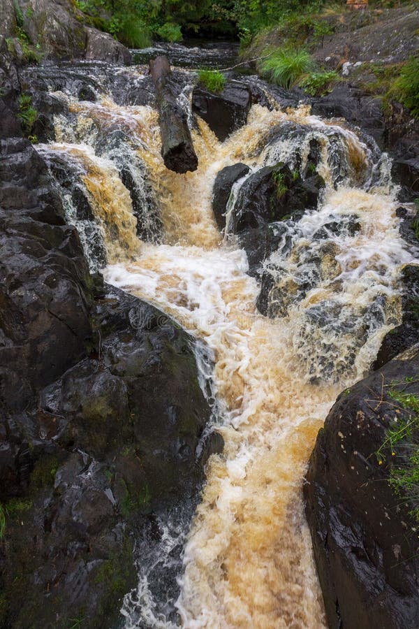 A Bubbling Fast Cold River with Cliffs and Waterfalls, a Mountain River ...
