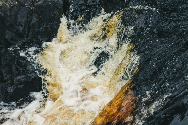 A Bubbling Fast Cold River with Cliffs and Waterfalls, a Mountain River ...