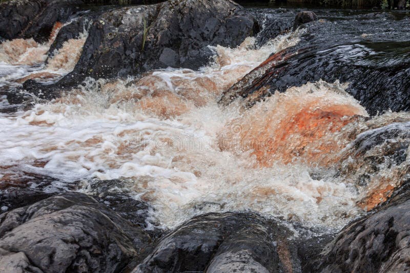 A Bubbling Fast Cold River with Cliffs and Waterfalls, a Mountain River ...