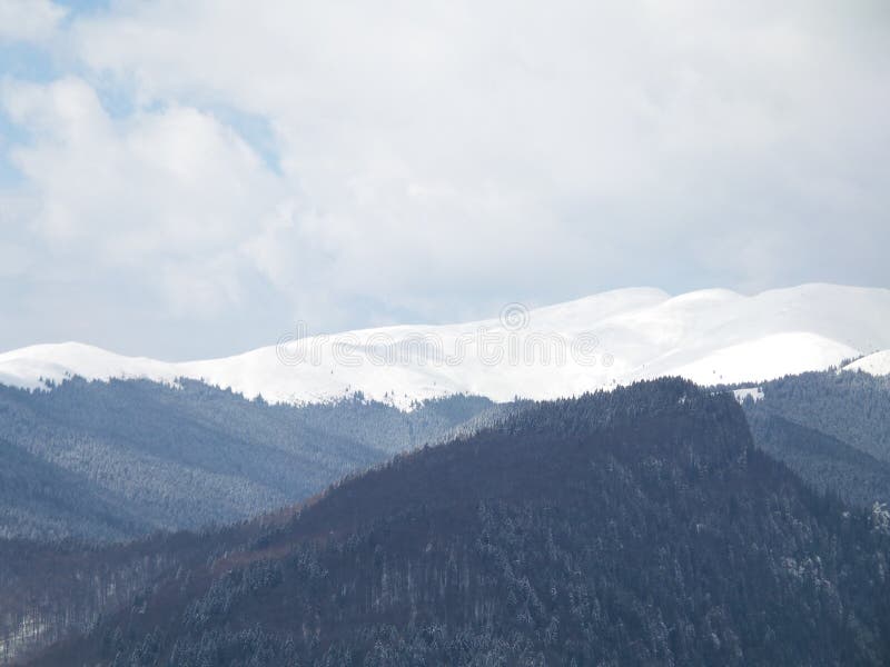 Bucegi Mountain Covered with Snow in a Cloudy Day Stock Photo - Image ...