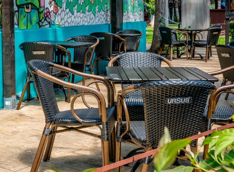 Wooden Chairs and Table on a Cobbled Street. Outdoor Restaurant Terrace ...