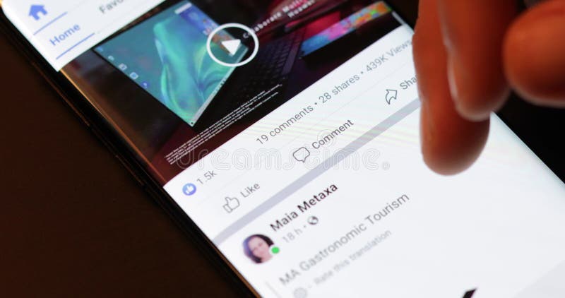 Details with the Hand of a Man Browsing through the Facebook App on a ... Details with the Hand of a Man Browsing through the Facebook App on a ...