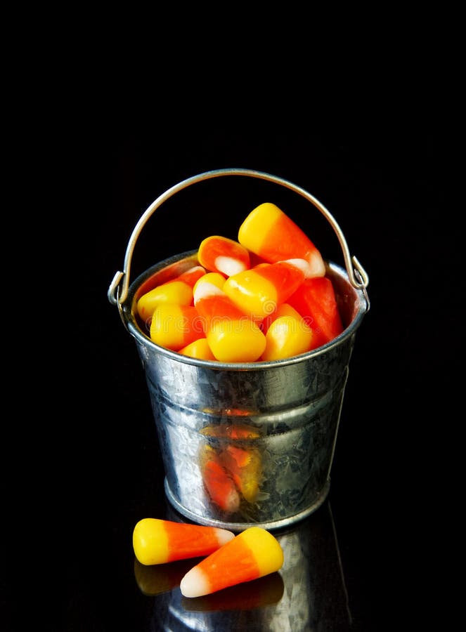 Candy Corn Spilling Out of a Glass Jar on a Wood Table Stock Photo ...